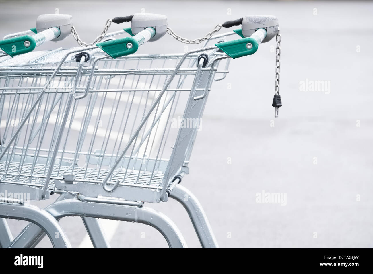 Trolley with coin operated lock in supermarket car park Stock Photo - Alamy