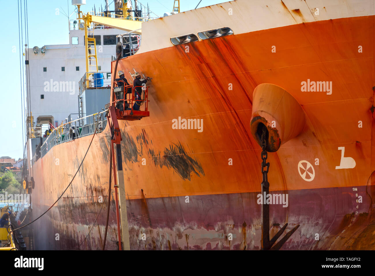 Cleaning and repainting of hulls of a big ship or big ship being fixed ...