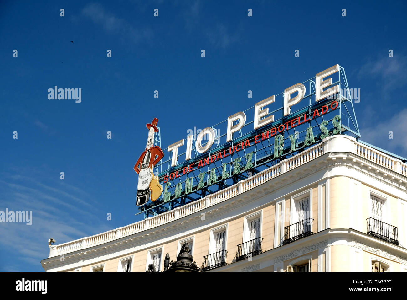 Iconic Tio Pepe sherry neon sign in daylight; Puerta del Sol square in ...
