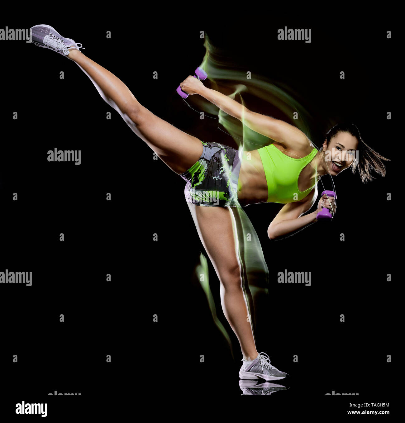 one mixed race woman exercising fitness exercises isolated on black ...