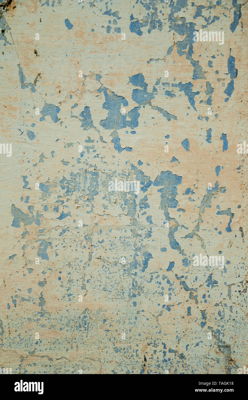 Close-up of wall covered by rough plaster with some cracks and chipped ...