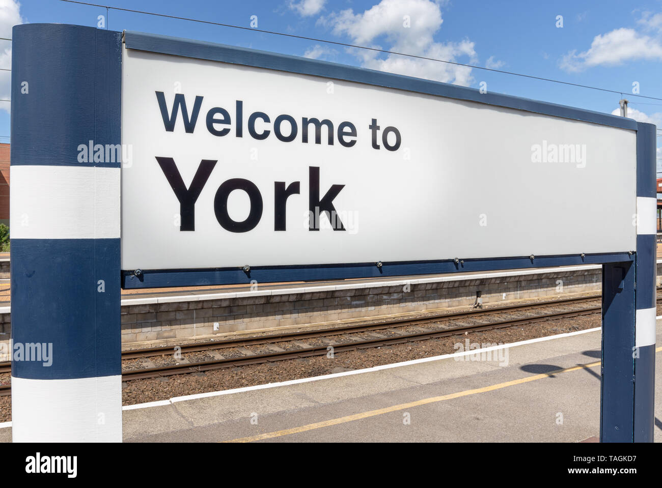 York Railway Station welcome sign in blue and white. Shadows fall onto ...