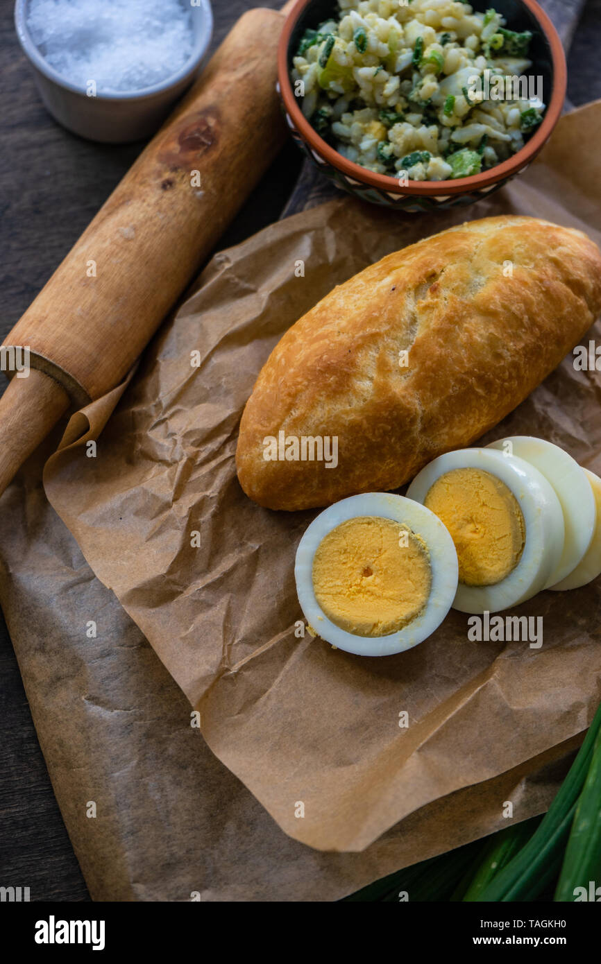 Traditional georgian pies with eggs, rice and green onion on dark ...