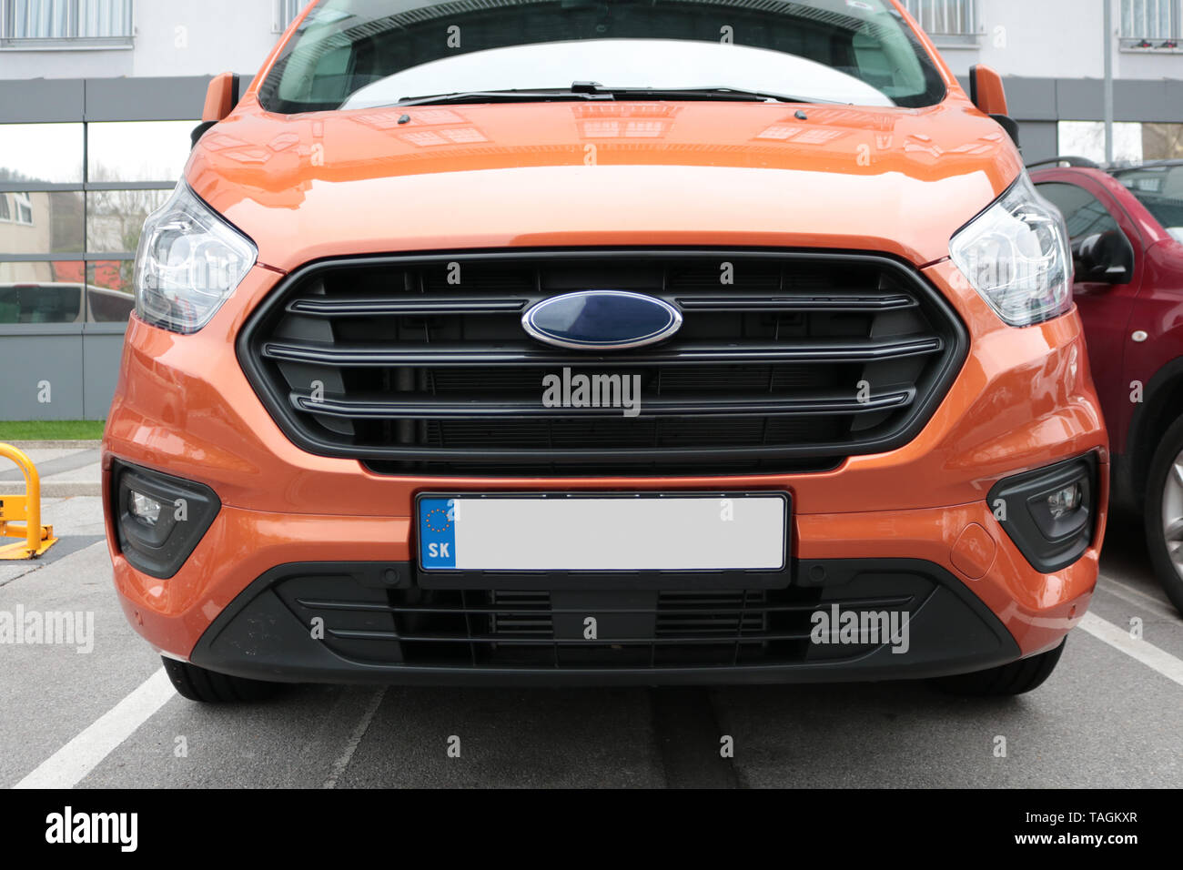 Empty License plate in the front of a orange car Stock Photo - Alamy