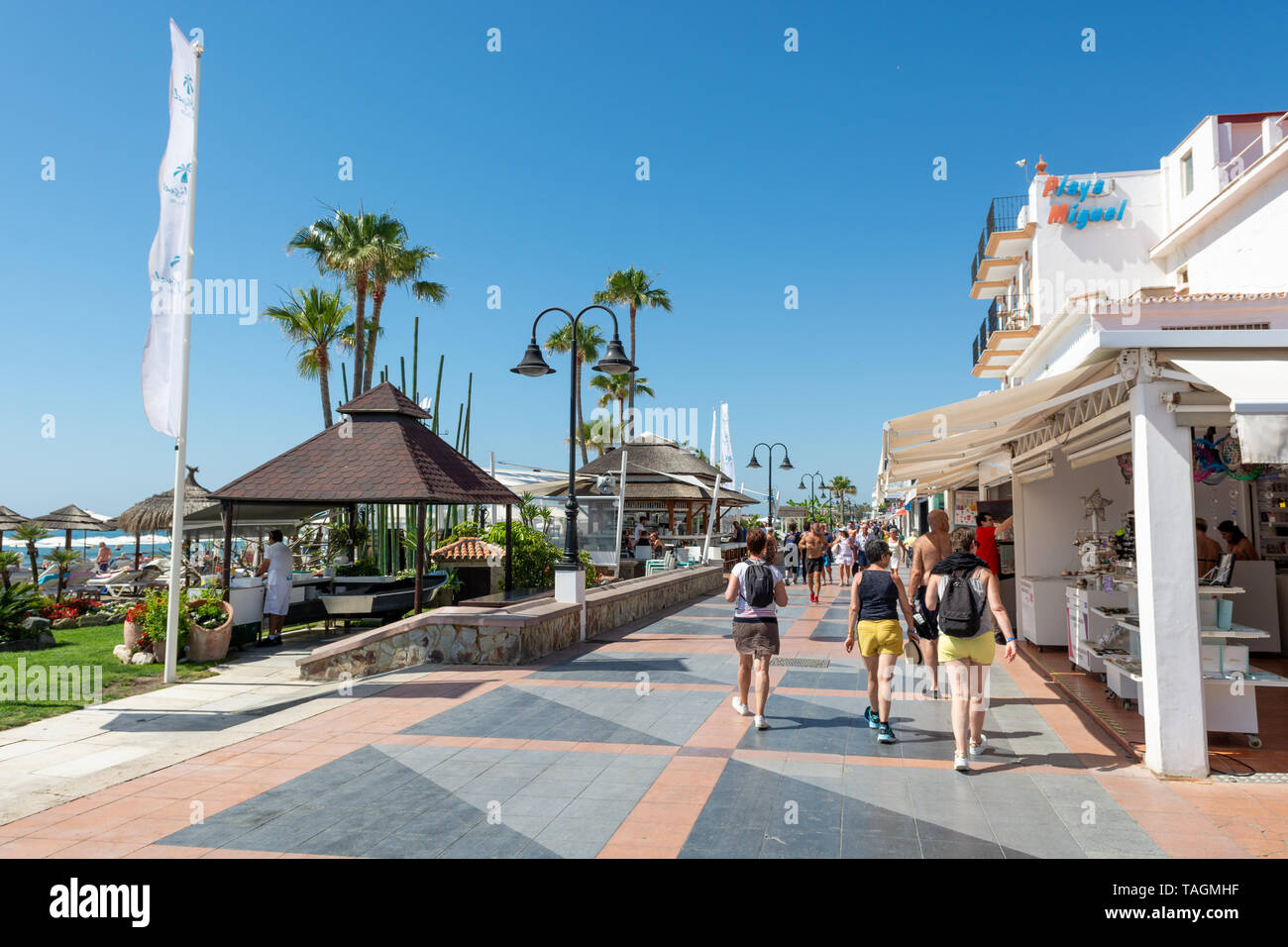 People walking along the promenade at La Carihuela, Torremolinos, Costa ...
