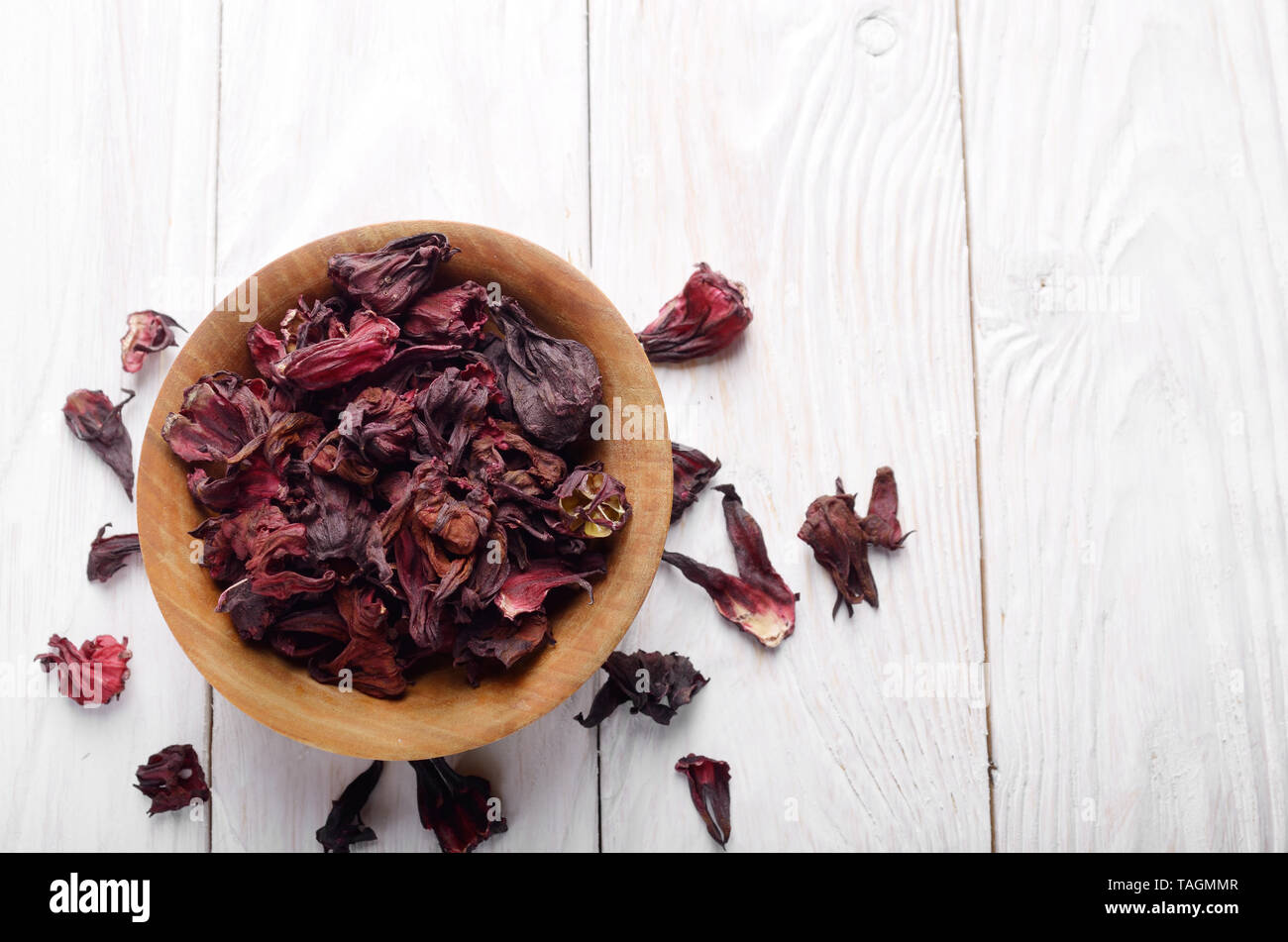 Top view at wooden bowl of dry hibiscus petals on white background Stock Photo - Alamy