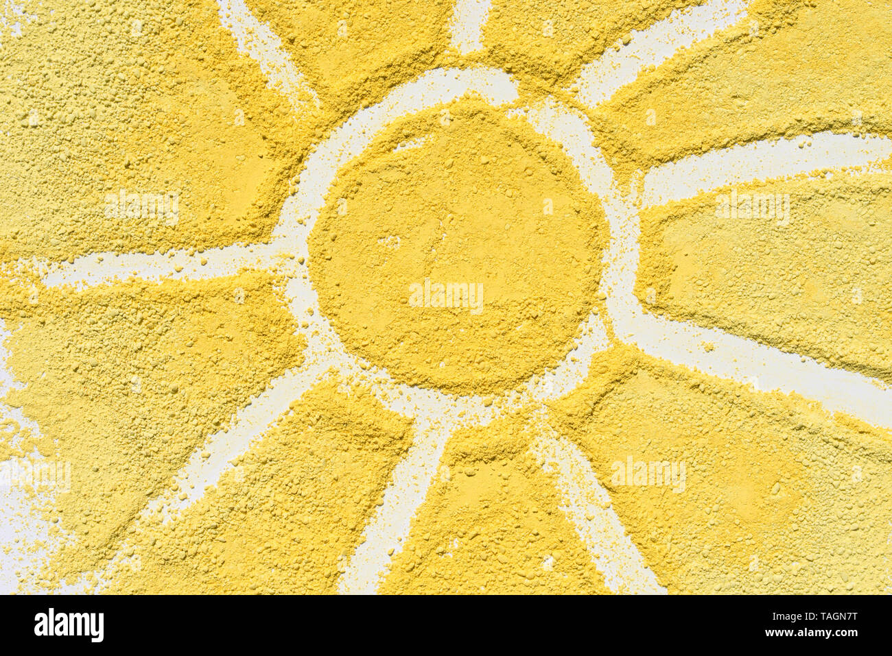 sun symbol on yellow powder pigment art texture background macro Stock ...