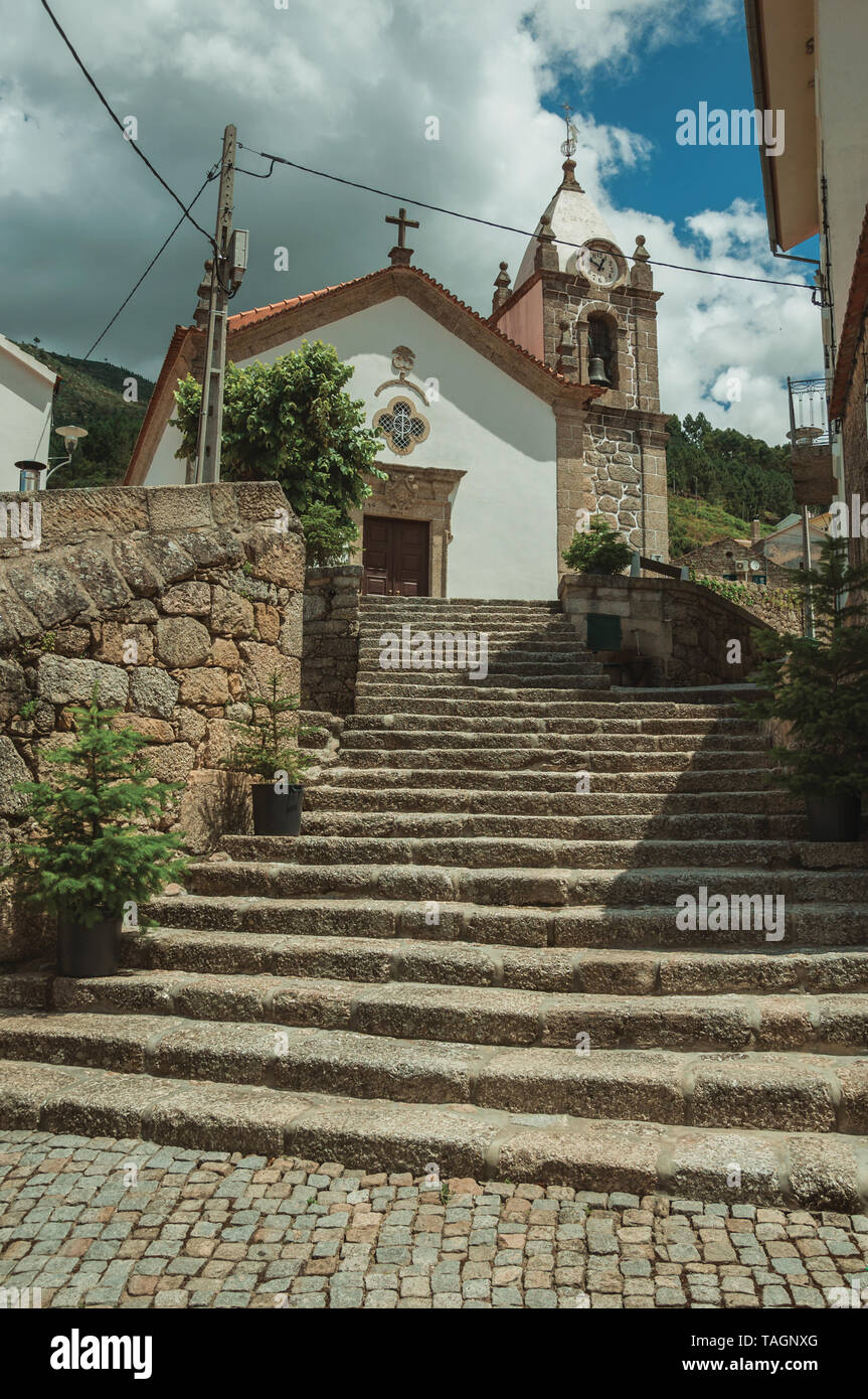 Old countryside church facade and steeple on top of stone staircase at ...
