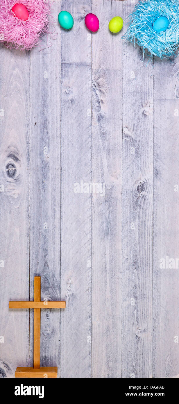 Easter cross and eggs overhead on wooden background with copy space ...
