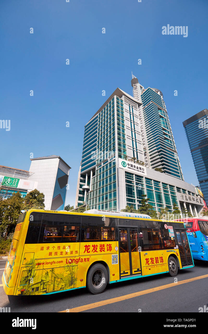 Electric city bus moving on street in Futian Central Business District ...