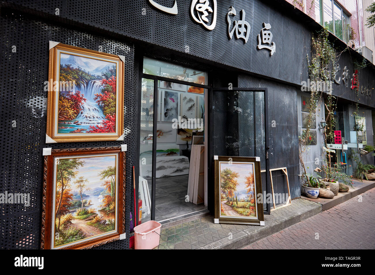 Local art gallery with paintings displayed outside. Dafen Oil Painting ...