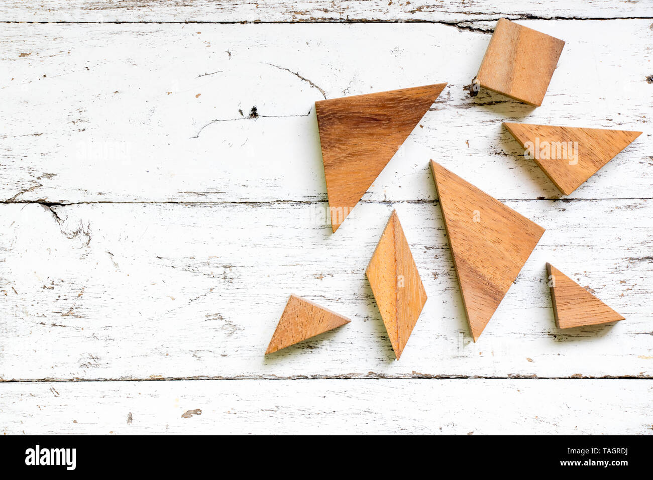 Tangram puzzle in piece wait to complete shape on old white wood ...