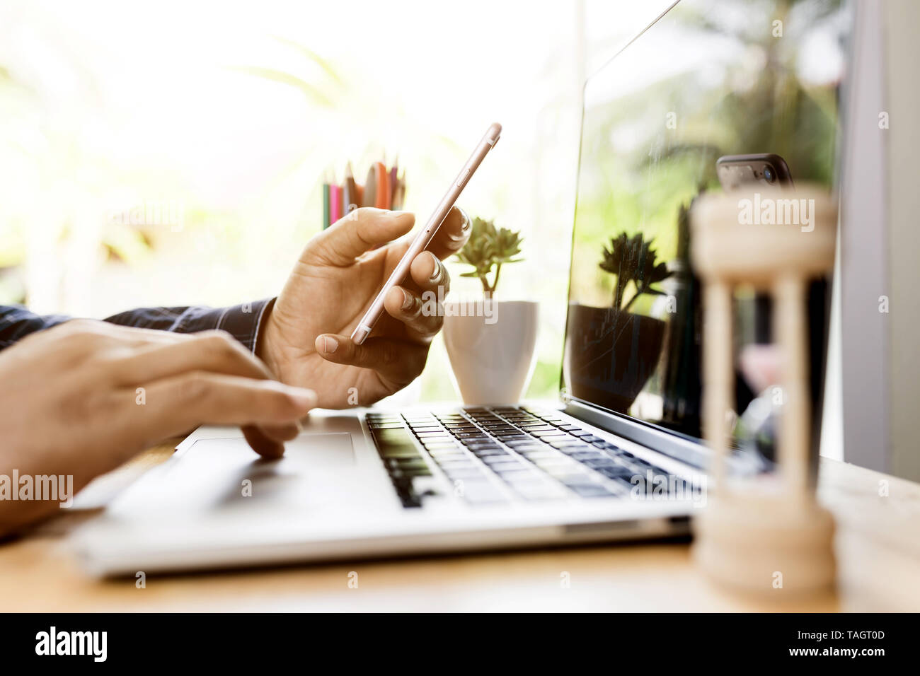 Close up business man hand working on laptop computer on wooden desk as ...