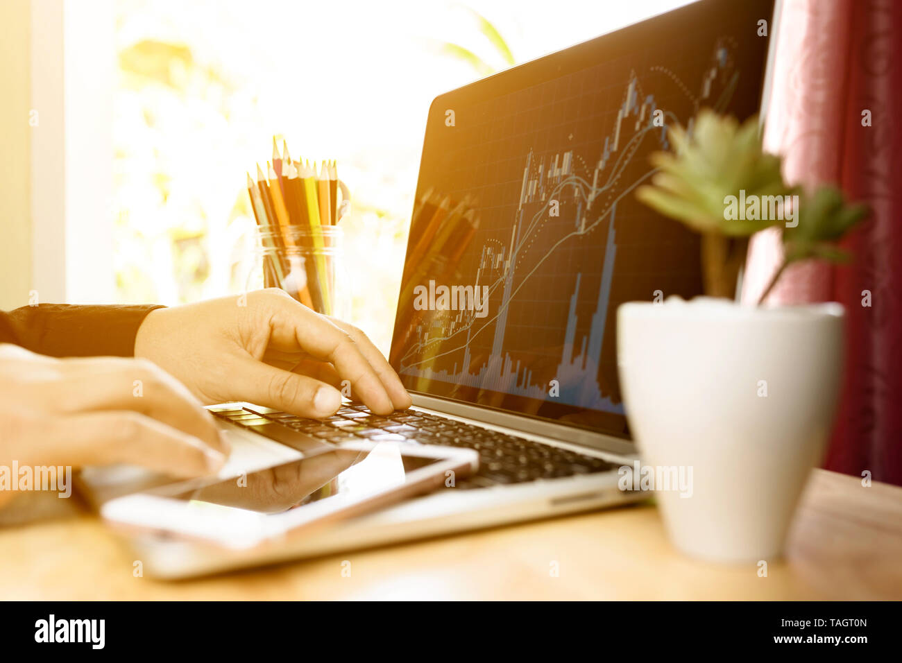 Close up business man hand working on laptop computer on wooden desk as ...