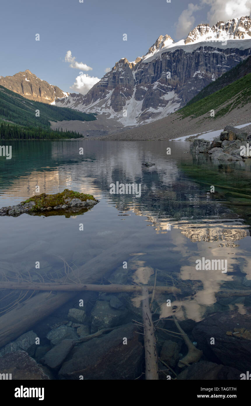Alpine lake with mountains in background Stock Photo - Alamy