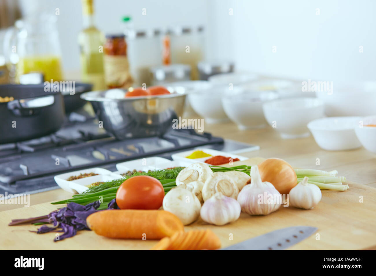 Composition with wooden board and ingredients for cooking on table ...
