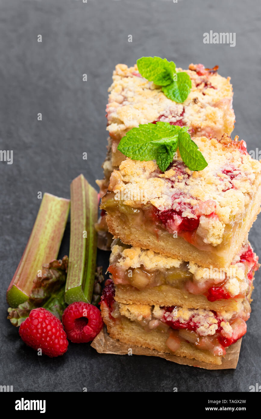 Homemade rhubarb tart with raspberry on black stone background Stock ...