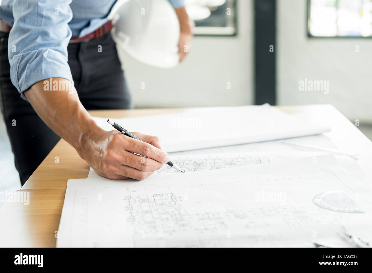 Person's engineer Hand Drawing Plan On Blue Print with architect ...