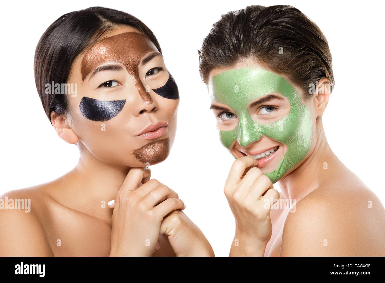 Two beautiful girls with colorful peel-off masks on their faces ...