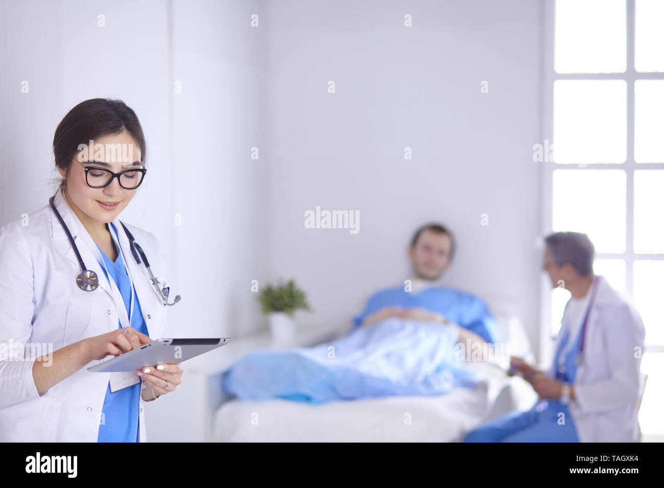 Doctor checking heart beat of patient in bed with stethoscope Stock ...