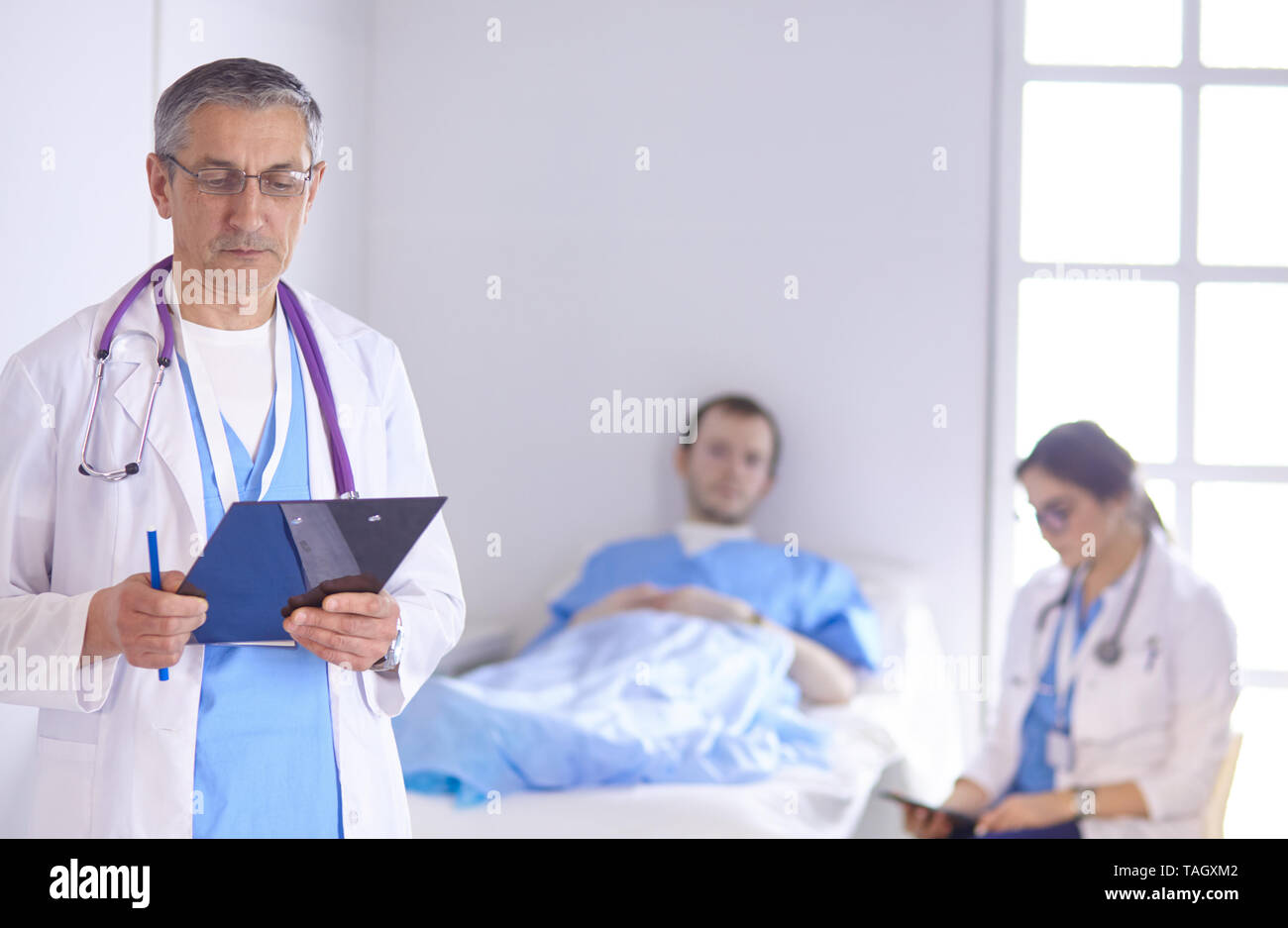 Doctor checking heart beat of patient in bed with stethoscope Stock ...