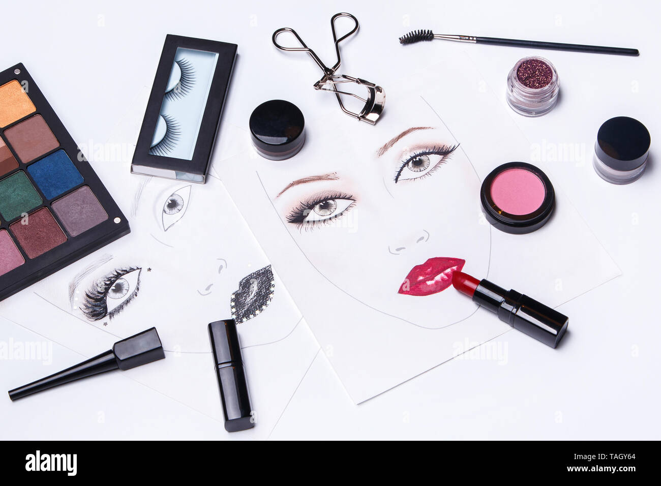 Face charts and different makeup objects and cosmetics on white ...
