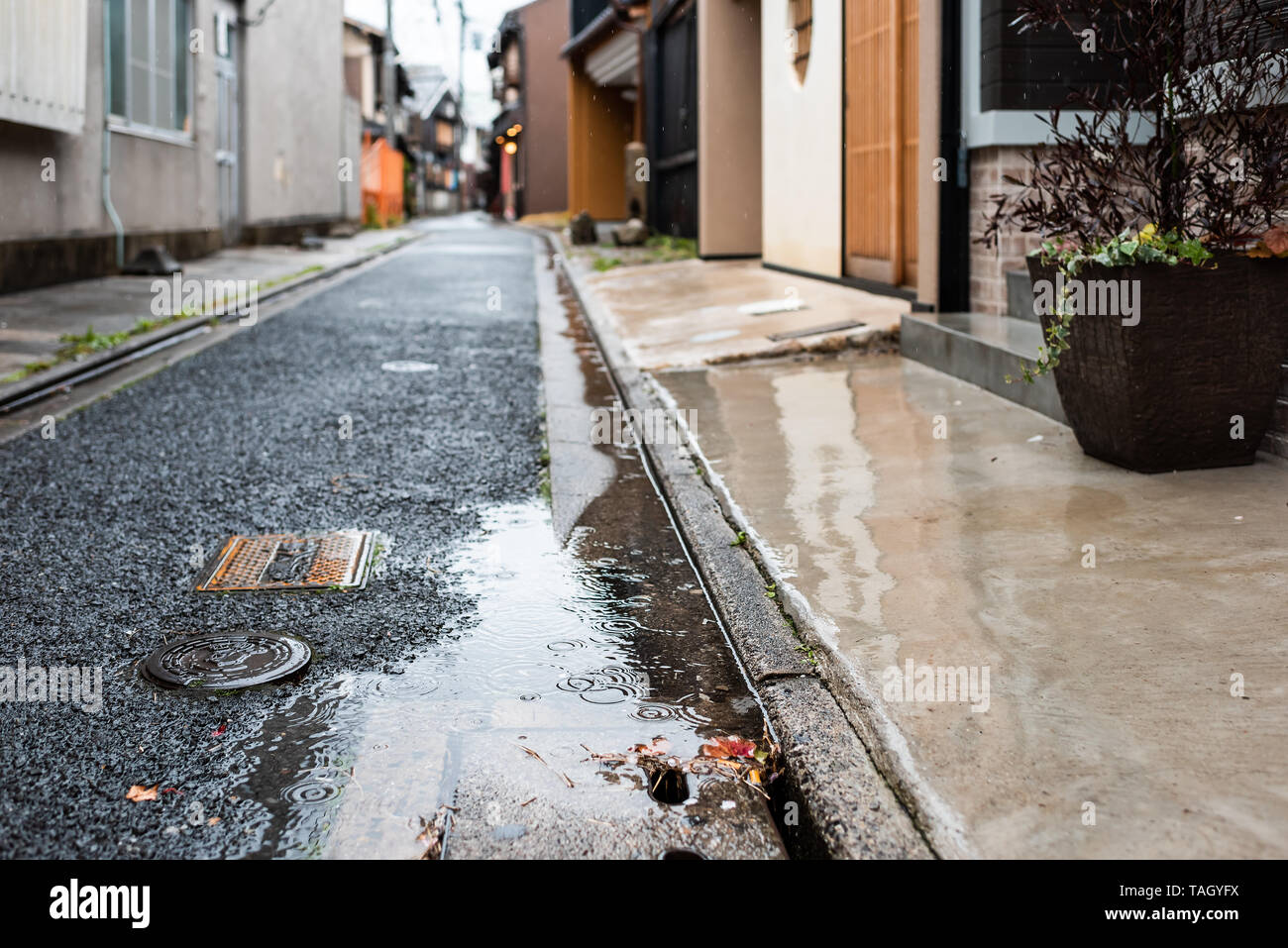 Puddle on alley street hi-res stock photography and images - Alamy