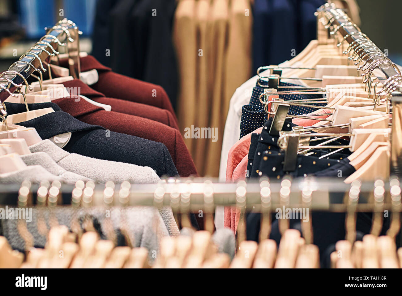 Fashion trend concept. Interior of clothes store with different women ...