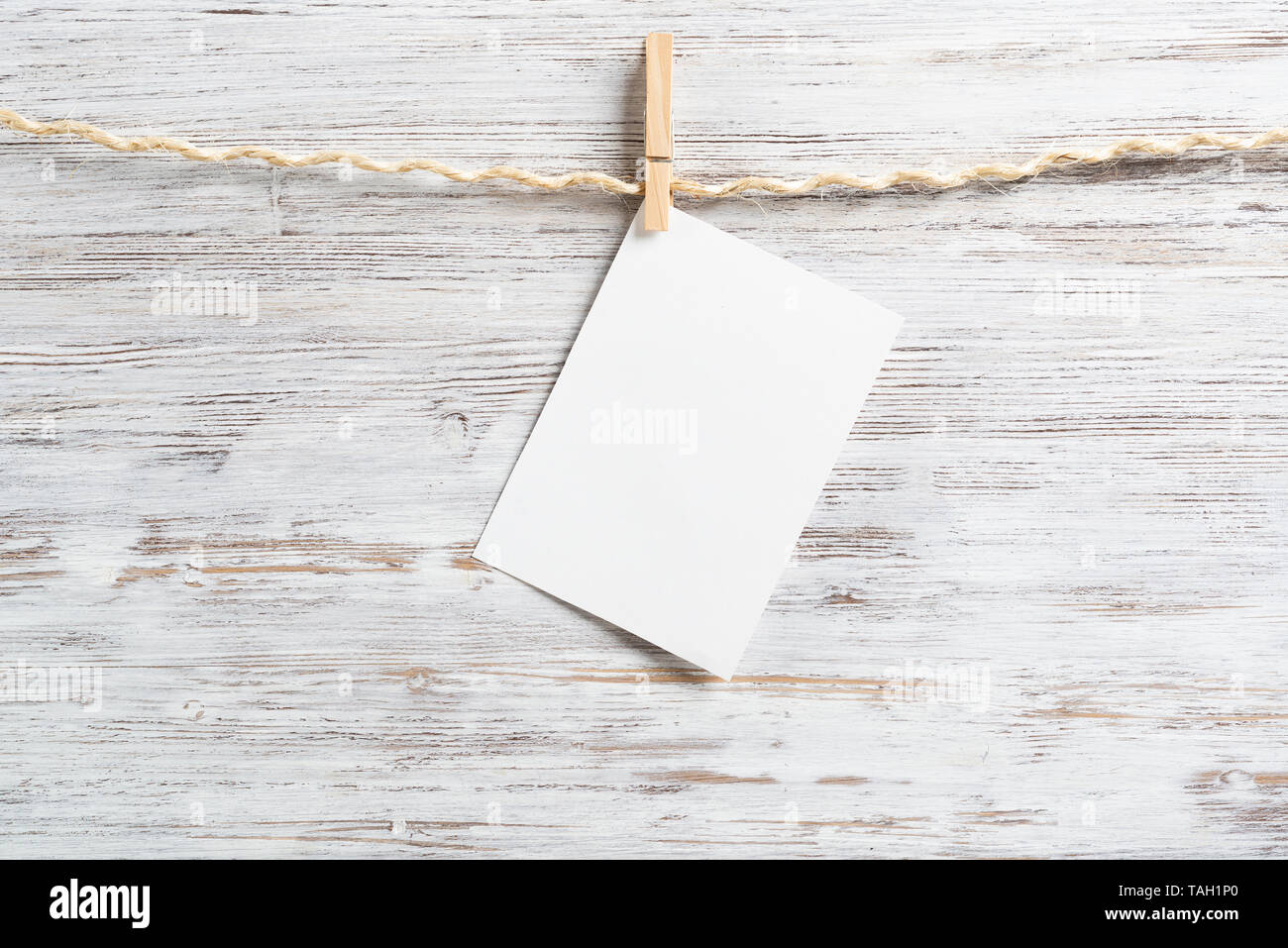 Blank sheet of white paper hanging on twine rope Stock Photo - Alamy