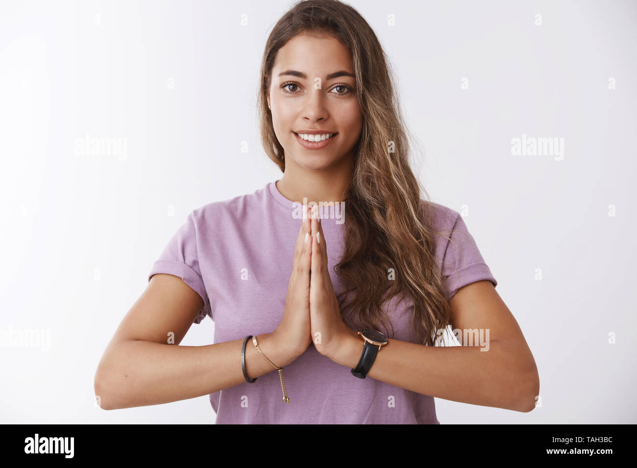 Attractive friendly smiling happy female practicing yoga meditating ...