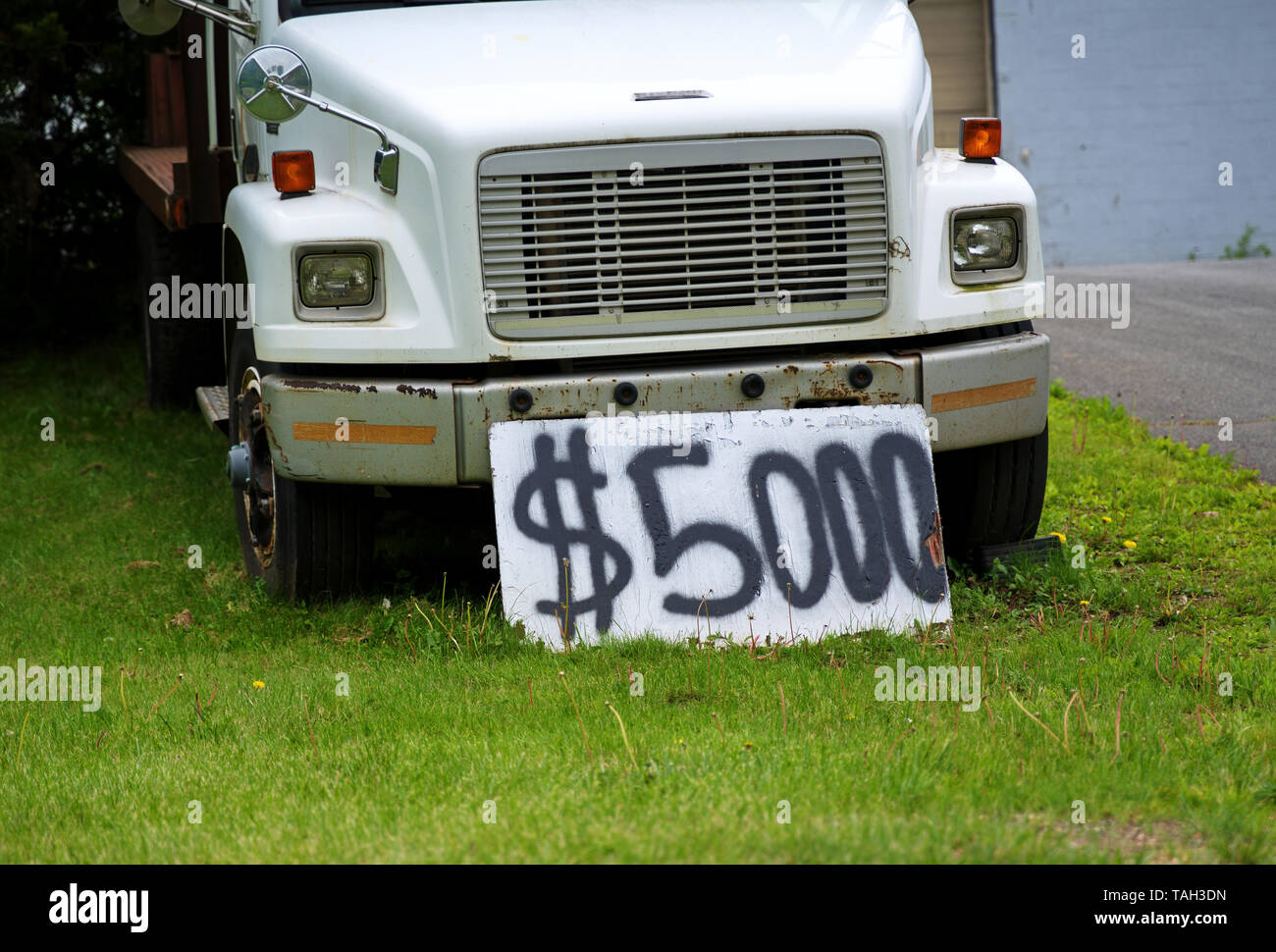 A used truck for sale with a hand painted price tag exhibiting a little ...