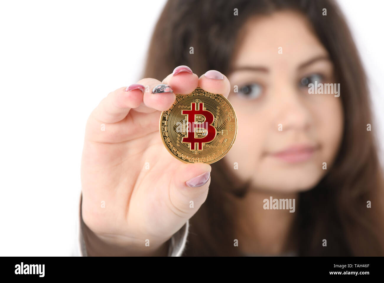 Pretty Girl holding in front of her new gilden cryptocurrency bitcoin ...