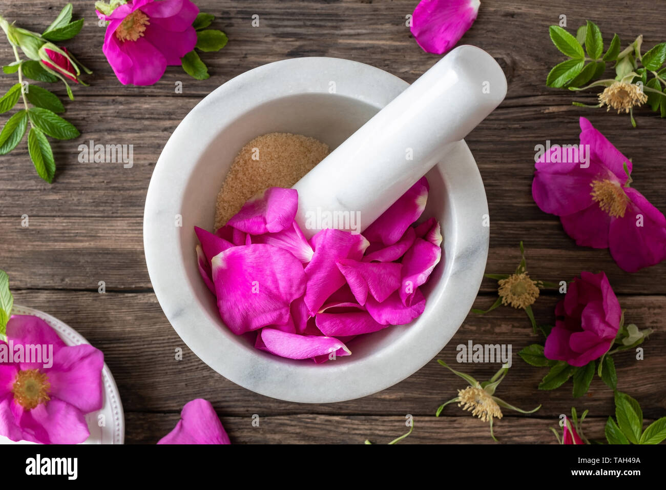 Fresh Rugosa rose petals with cane sugar in a mortar, top view Stock ...