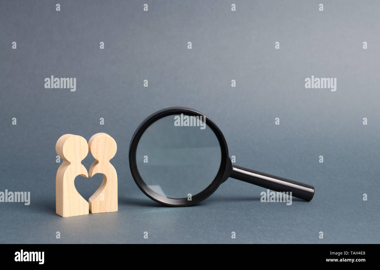 A young Couple of lovers of lovers are standing near to a magnifying ...