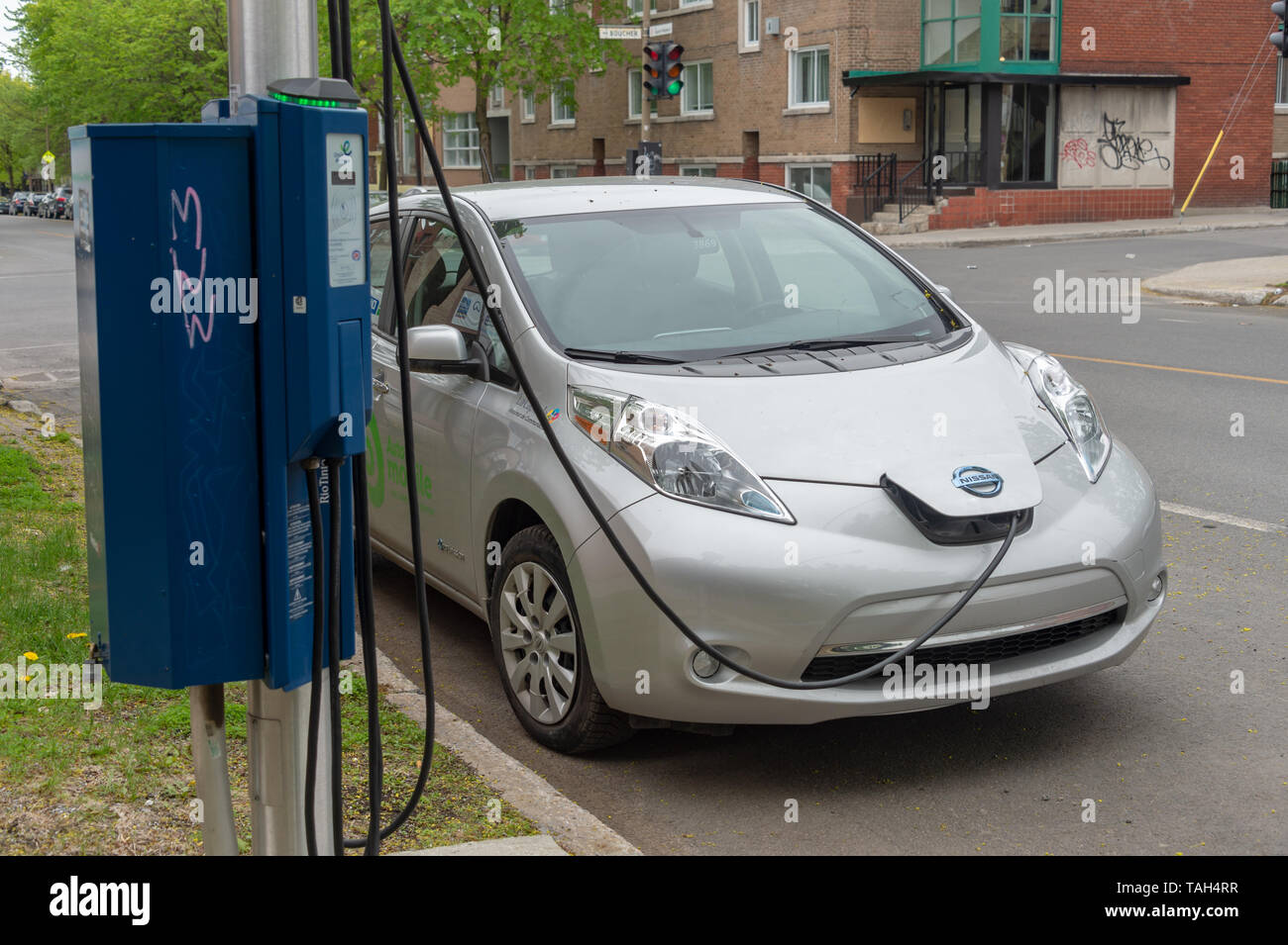 Montreal, CA - 25 May 2019: Electric car plugged into an EV charging ...