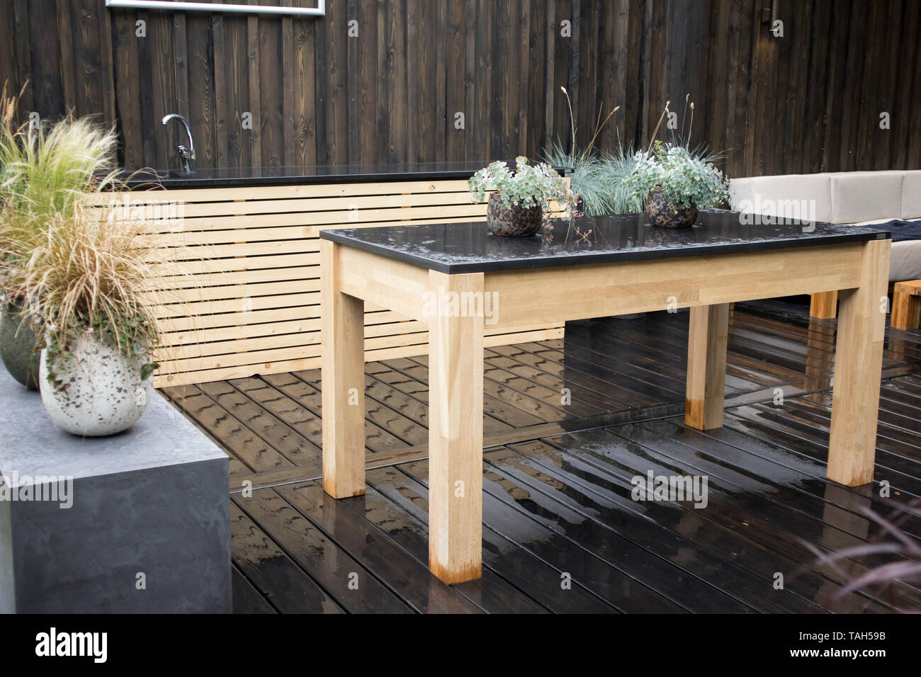 the Table with plants on the veranda in the garden Stock Photo - Alamy