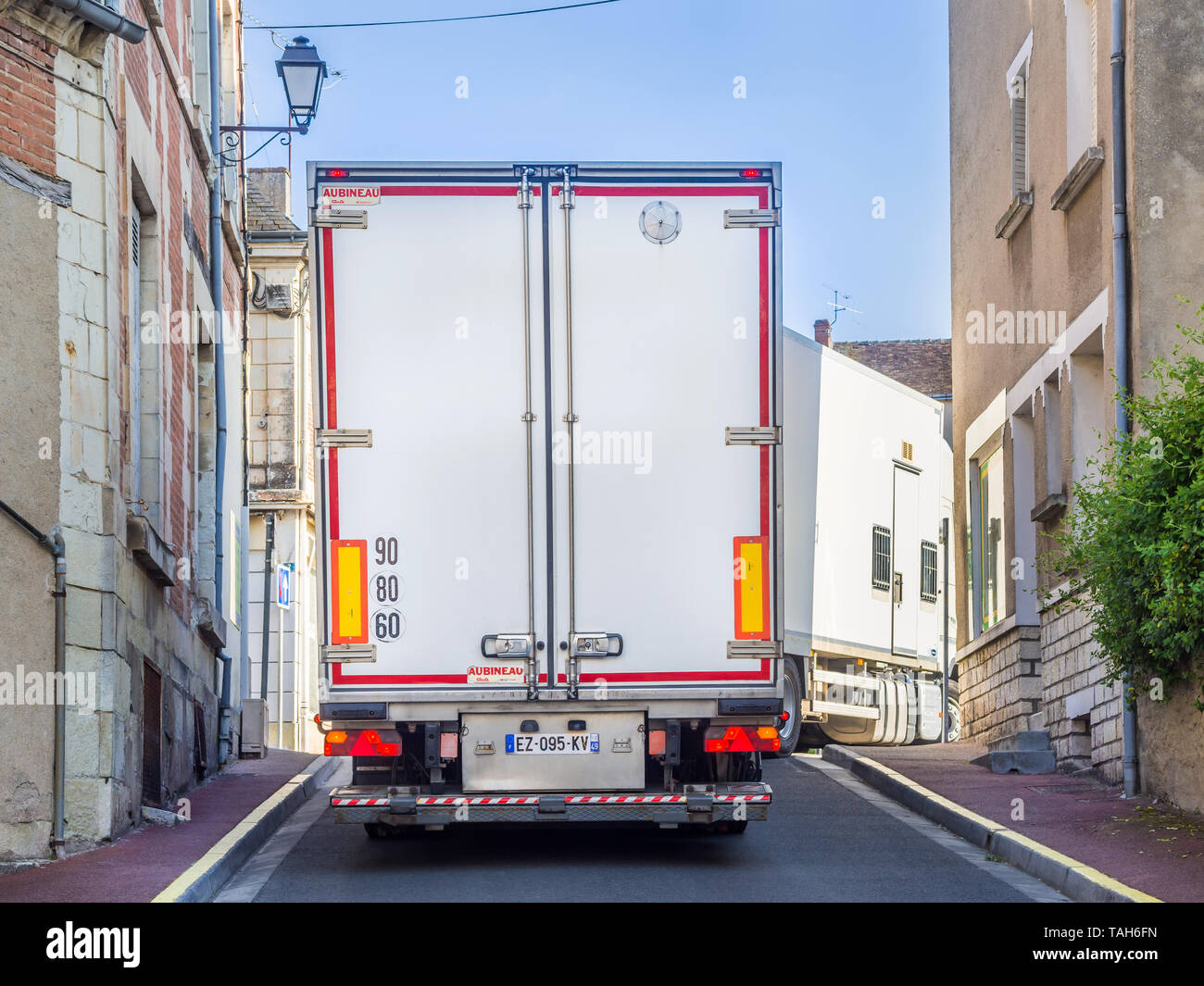 Long lorry and trailer stuck in narrow village street - France Stock ...