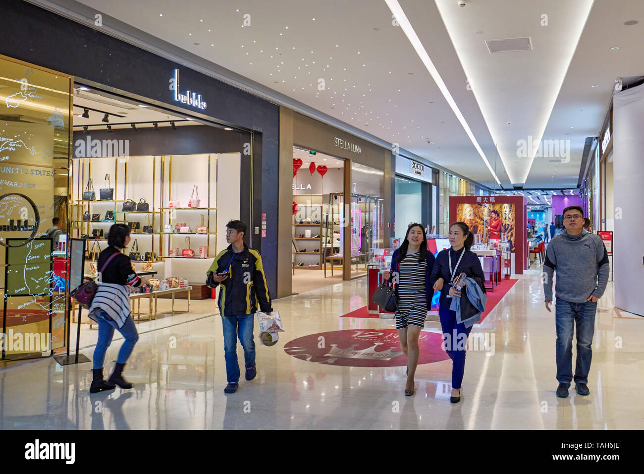 People walking in COCO Park shopping mall. Shenzhen, Guangdong Province ...