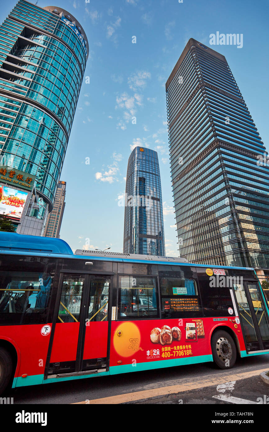 Electric city bus moving on street in Futian Central Business District ...
