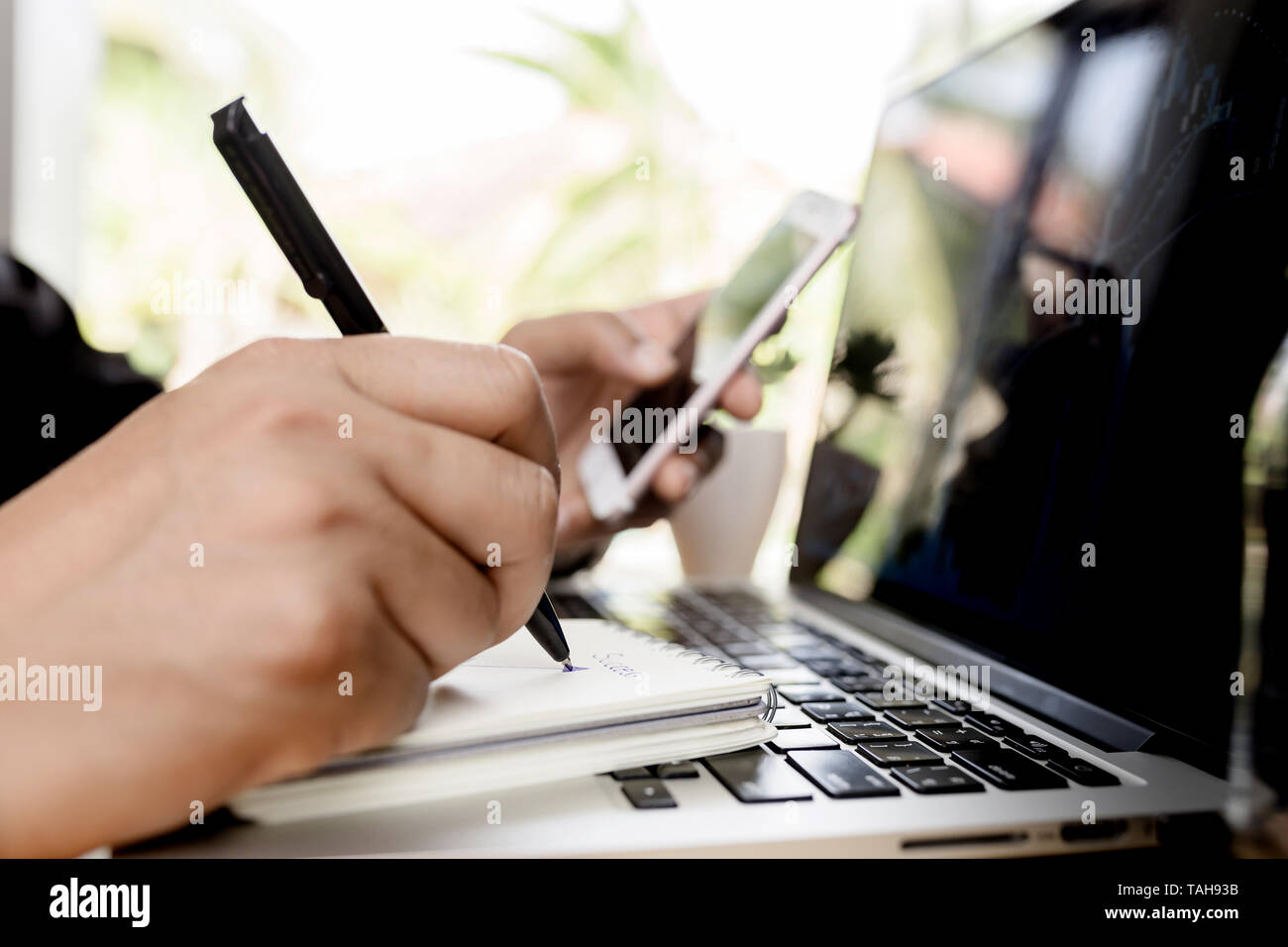Close up business man hand working on laptop computer on wooden desk as ...