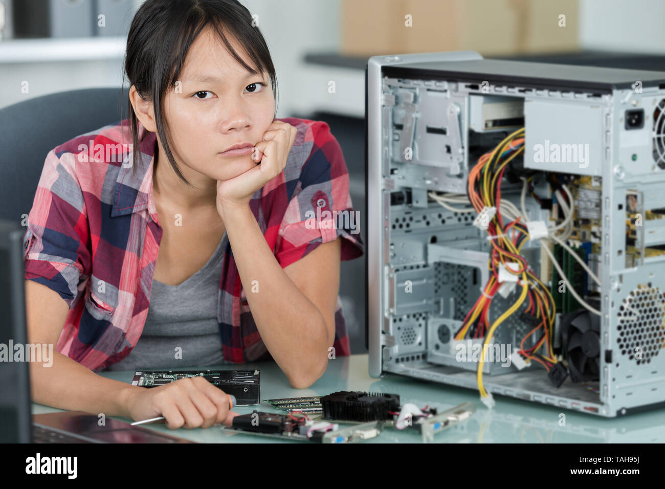 upset engineer woman ready to fix hard disk Stock Photo - Alamy