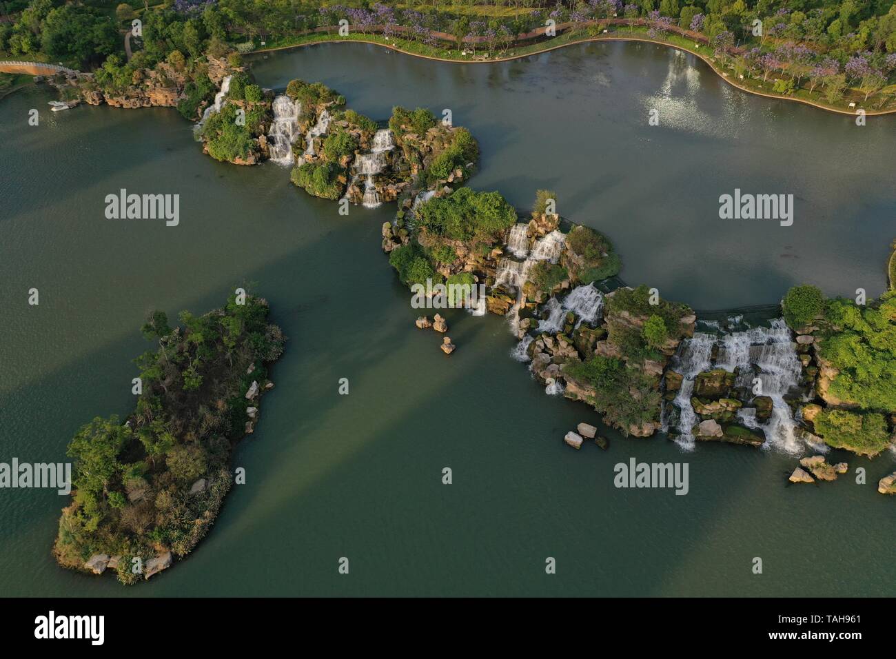 Aerial view of the Kunming Waterfall Park at sunset, one of the largest ...