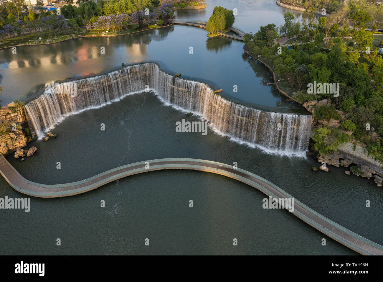 Aerial view of the Kunming Waterfall Park at sunset, one of the largest ...