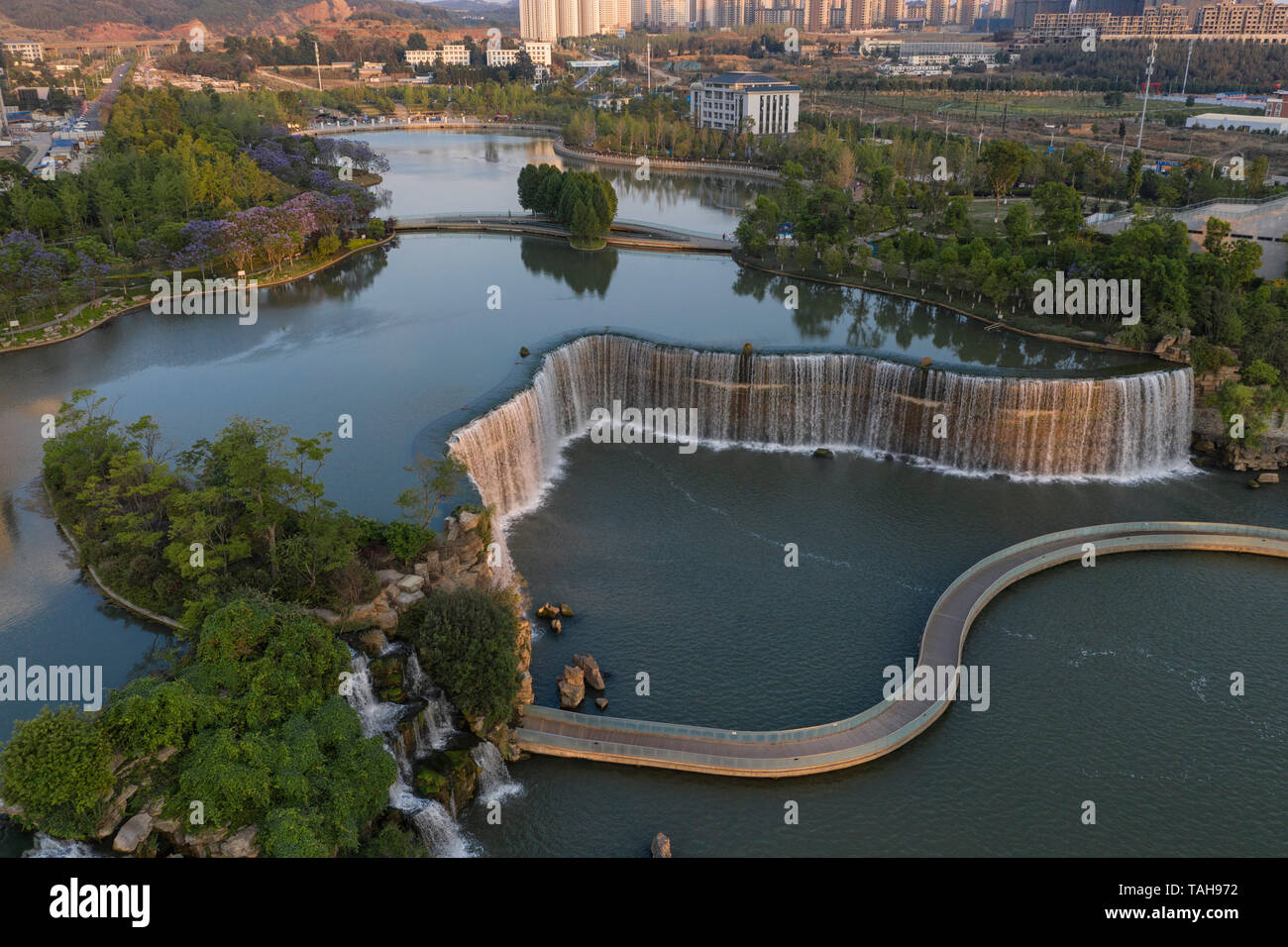 Aerial 360 degree view of the Kunming Waterfall Park at sunset, one of ...