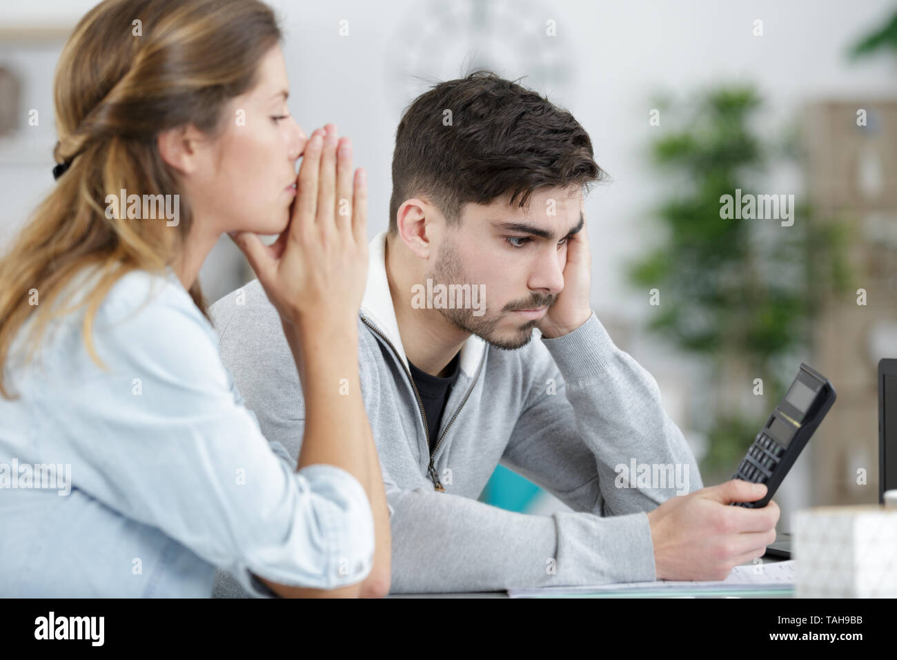 depressed couple calculating their finances Stock Photo - Alamy