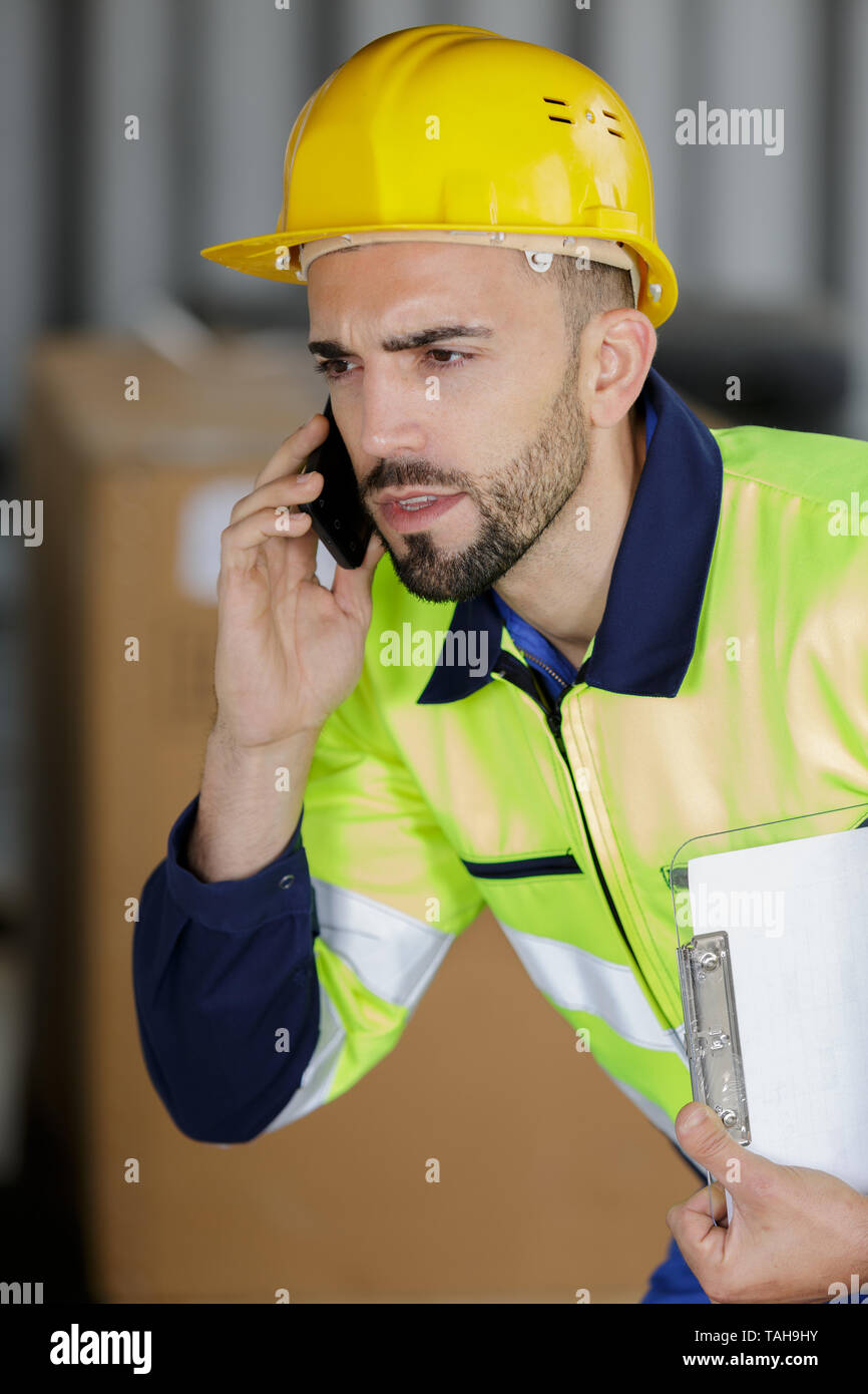 worker in overalls on the phone Stock Photo - Alamy