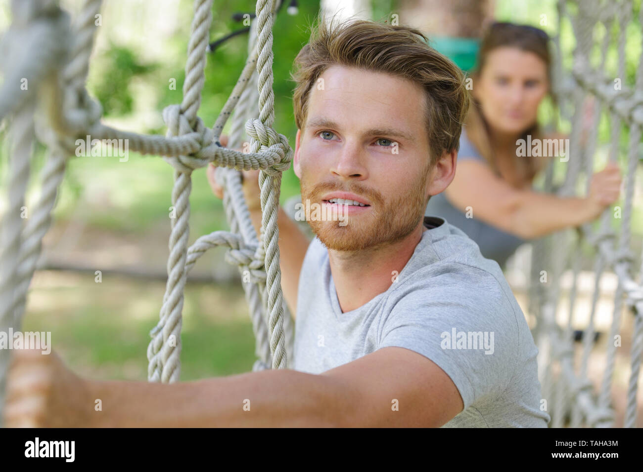couple crossing rope bridge Stock Photo - Alamy