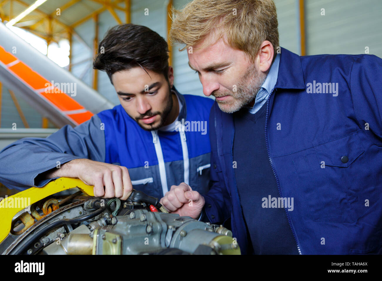 men working on engine of the airplane Stock Photo - Alamy
