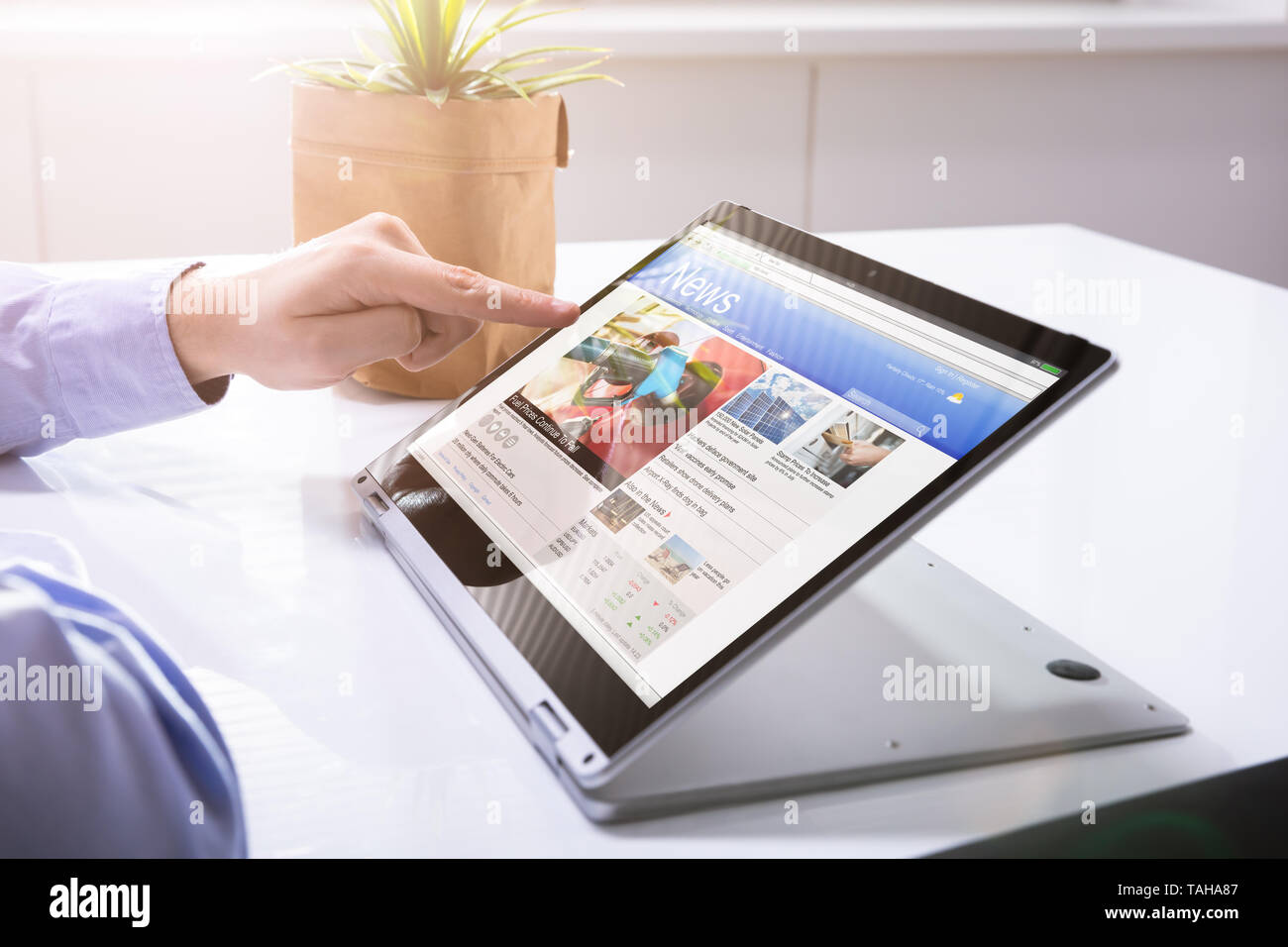 News checking hi-res stock photography and images - Alamy