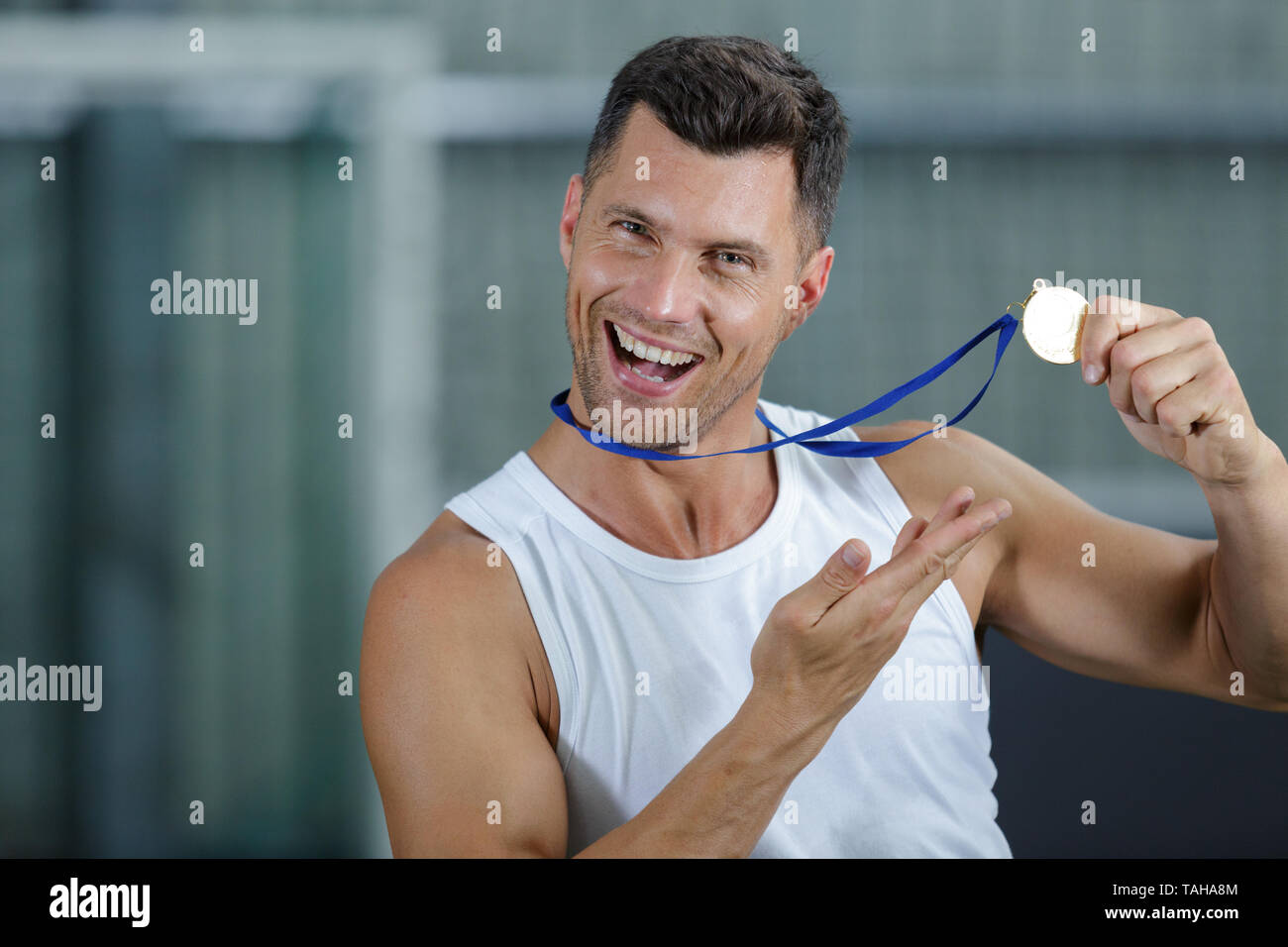 athlete holding medal Stock Photo - Alamy